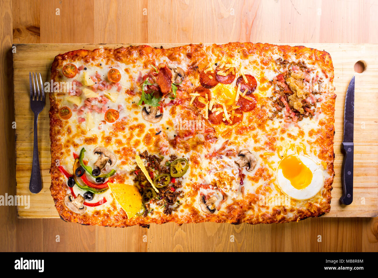 square pizza with many different ingredients Stock Photo - Alamy