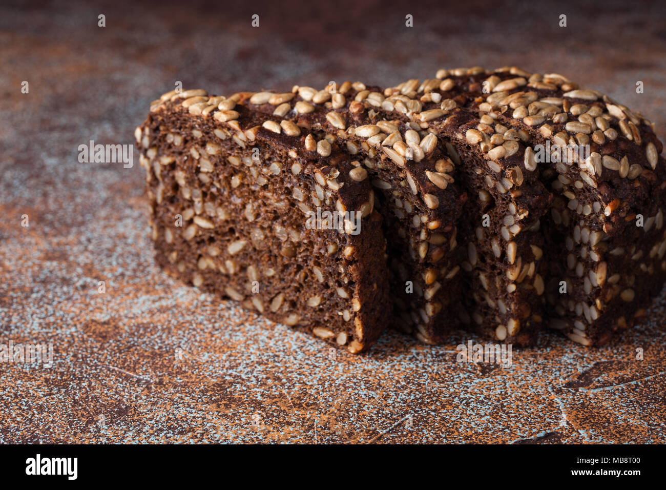 Fresh black bread with sunflower seeds on an old rusty table Stock ...