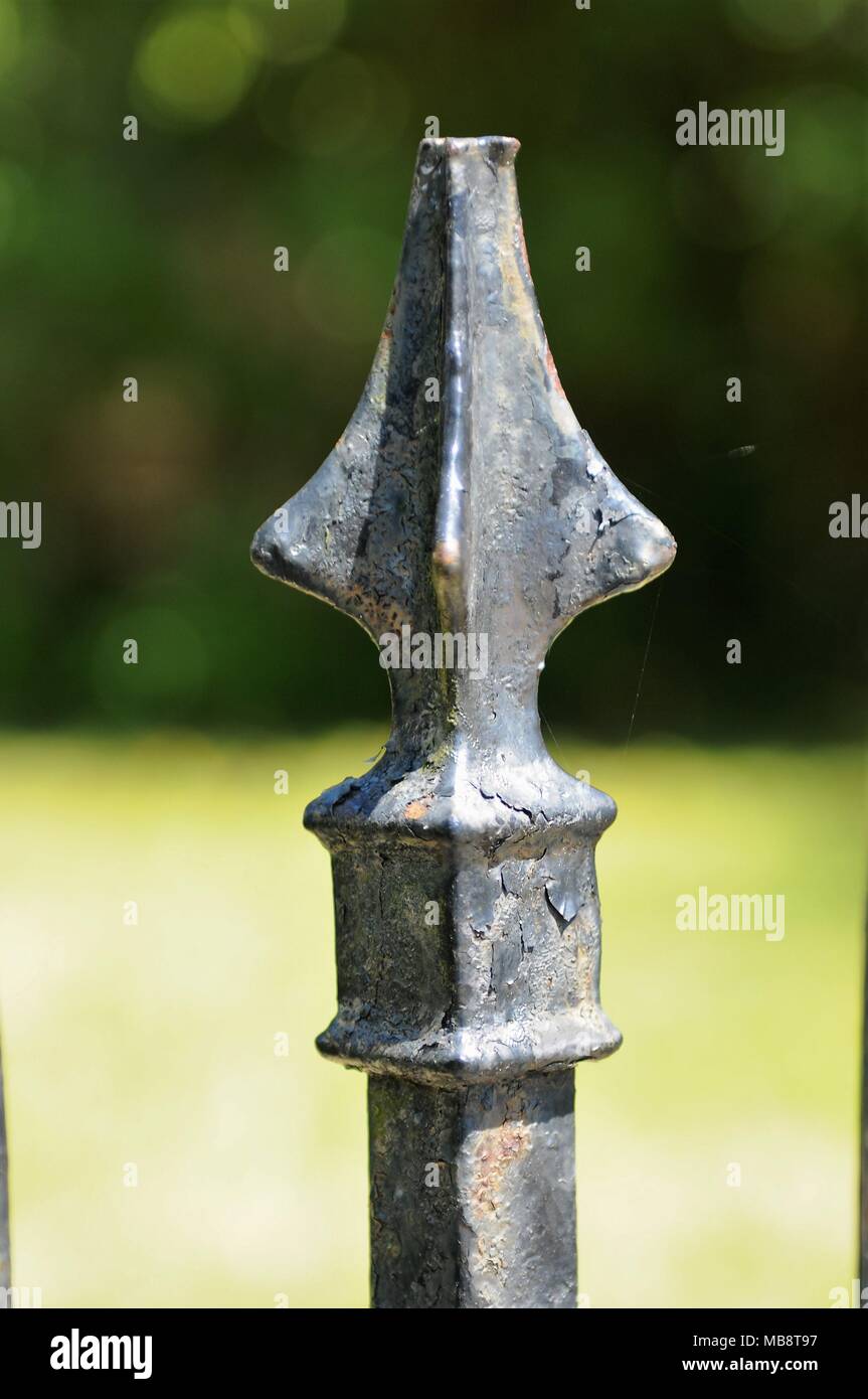 Old wrought iron fence with a triangular pointed fence post Stock Photo ...