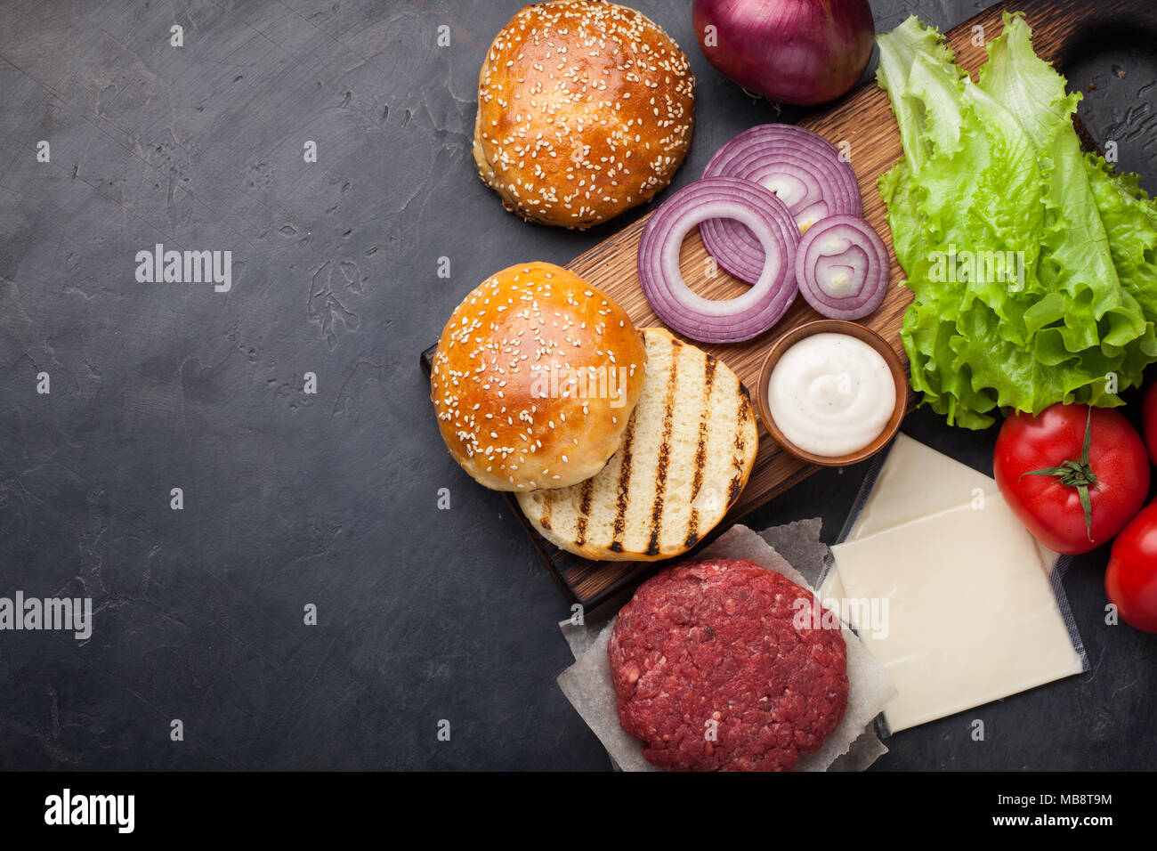 Hamburger Building Kit. Fresh ingredients for Burger on dark stone ...