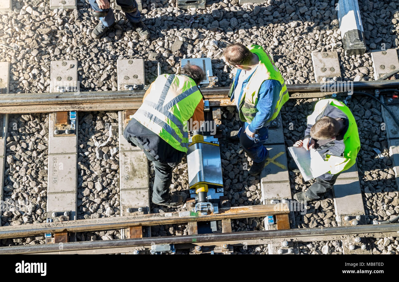 Railroad workers inspecting progress on train tracks, renovation works ...
