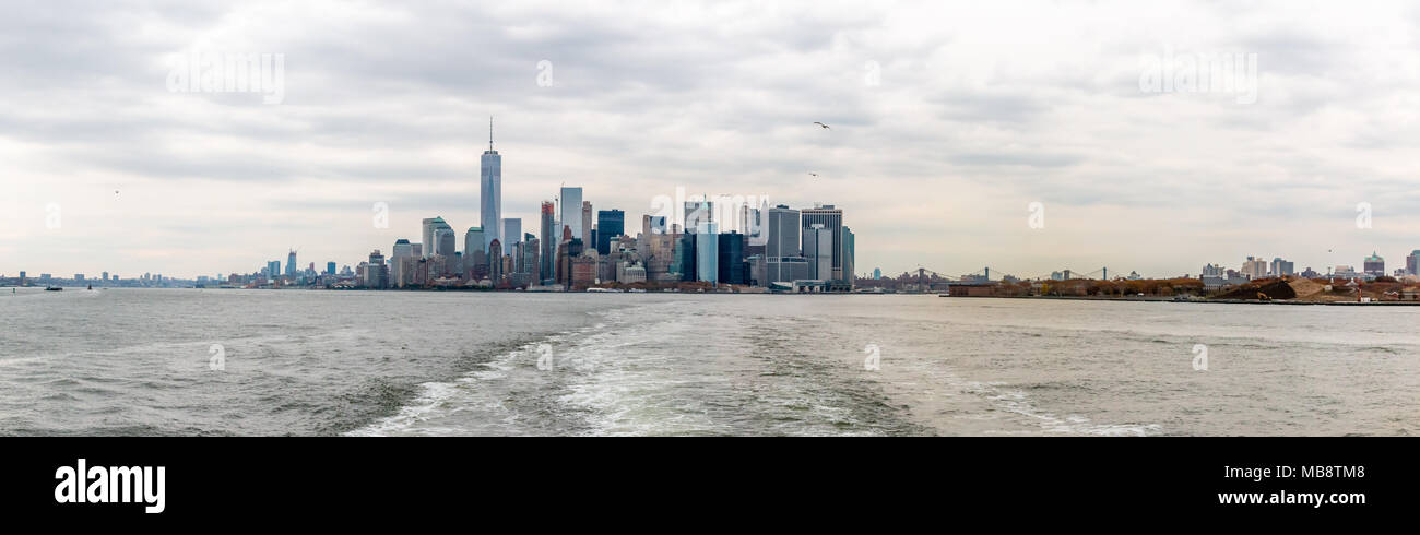 Manhattan Skyline From The Water With Cloudy Skies in Fall Season Stock ...