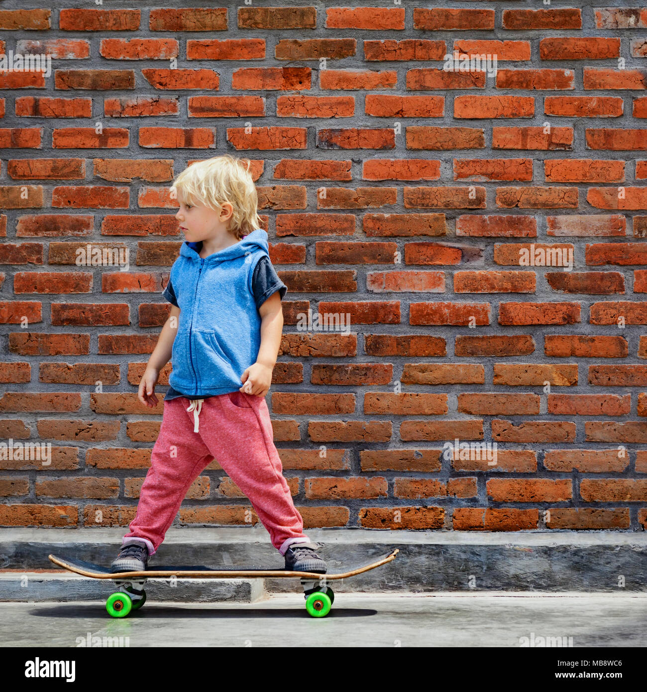Little skater on skateboard have fun before children training class in ...