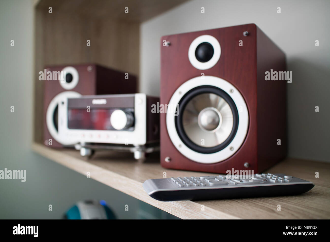 Wooden audio speakers and TV remote control on the shelf Stock Photo ...