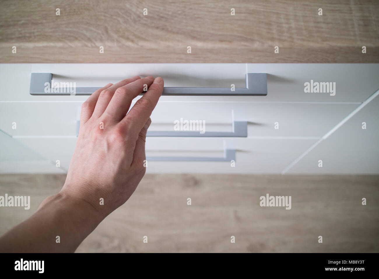 detail man hand is open of a laminate stylish kitchen drawer Stock ...