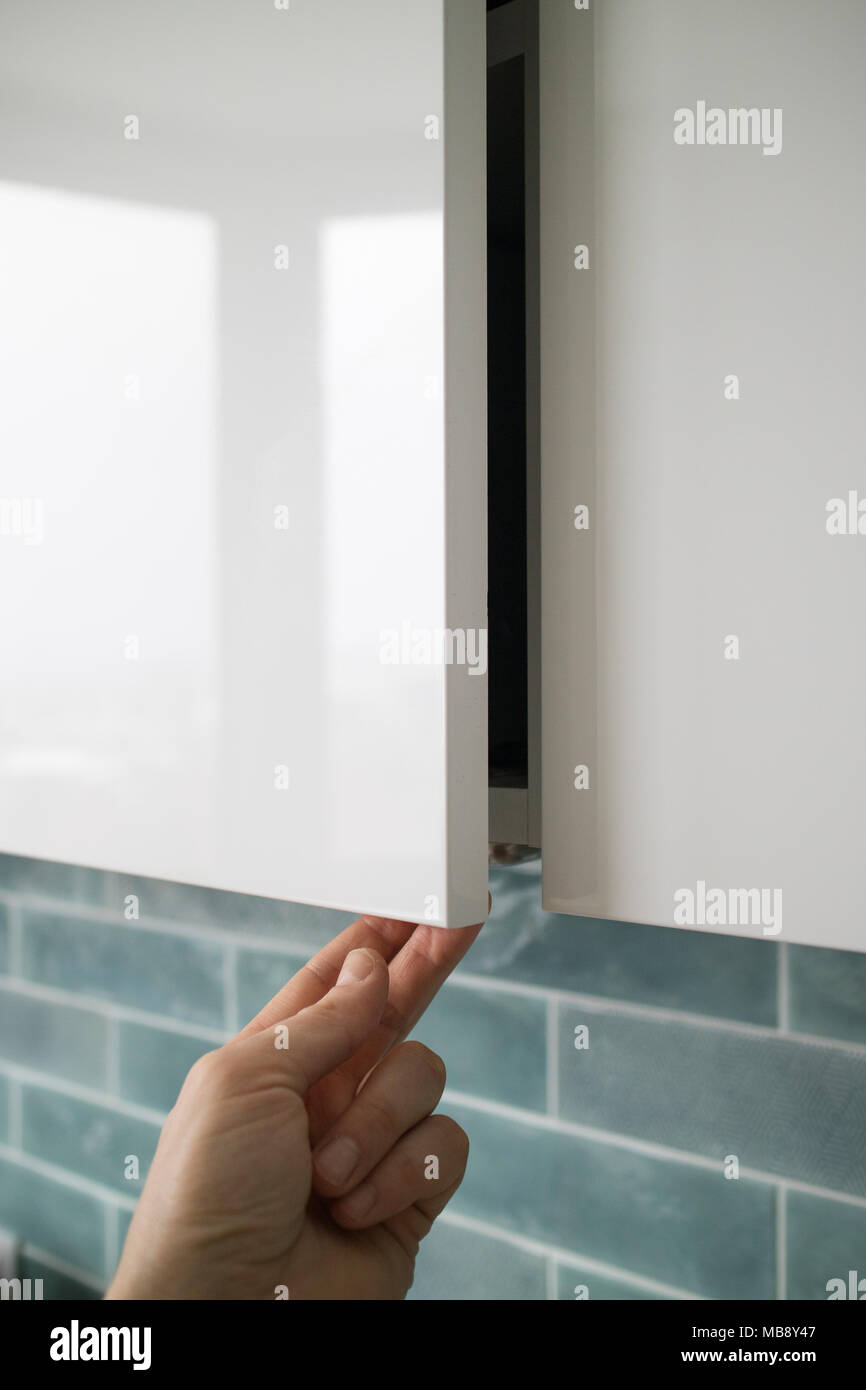 man hand opening or closing kitchen cabinet door Stock Photo - Alamy