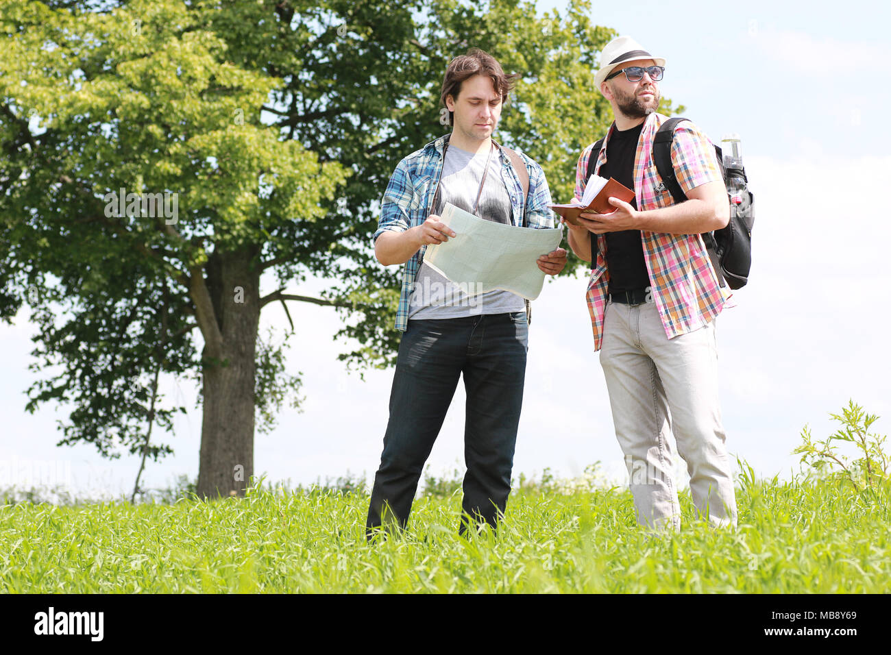 A young man looks at a map Stock Photo - Alamy