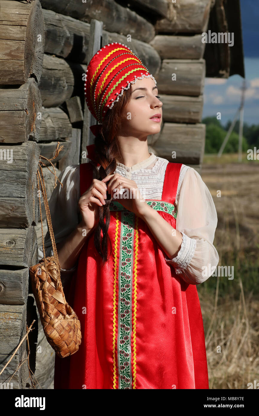 girl in traditional dress wooden wall Stock Photo - Alamy