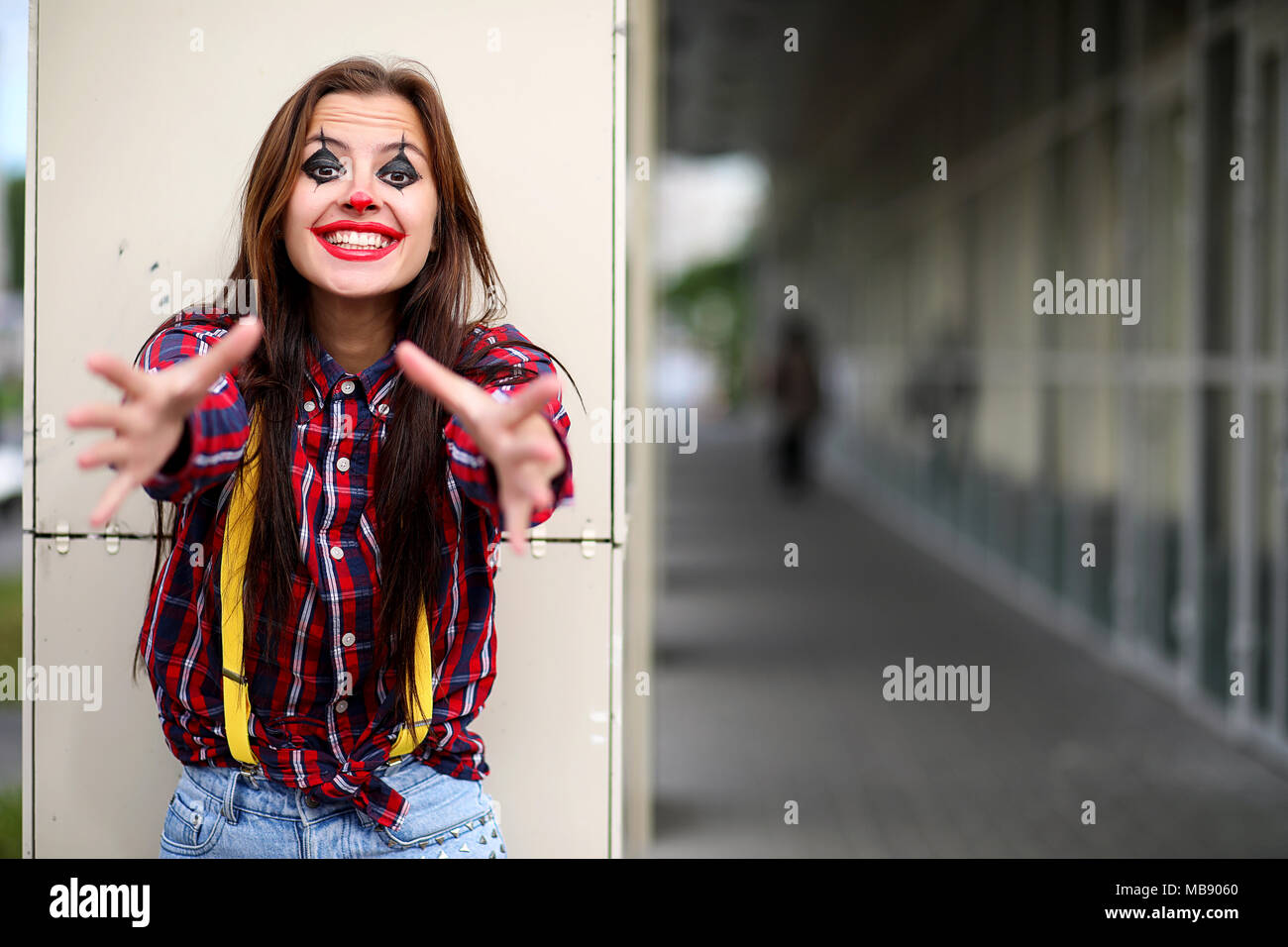 Cute girl in a clown makeup Stock Photo - Alamy