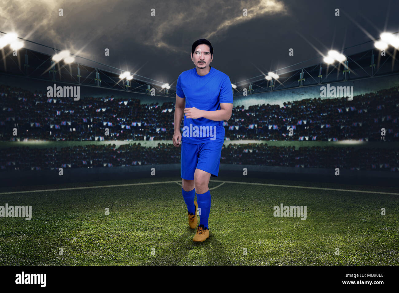 Handsome asian football player playing football on stadium Stock Photo ...