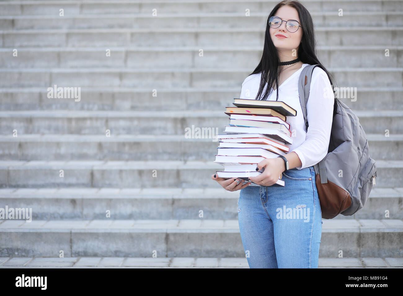 Girl student on the street with books Stock Photo - Alamy