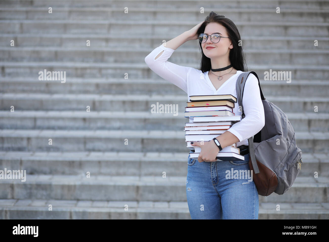 Girl student on the street with books Stock Photo - Alamy