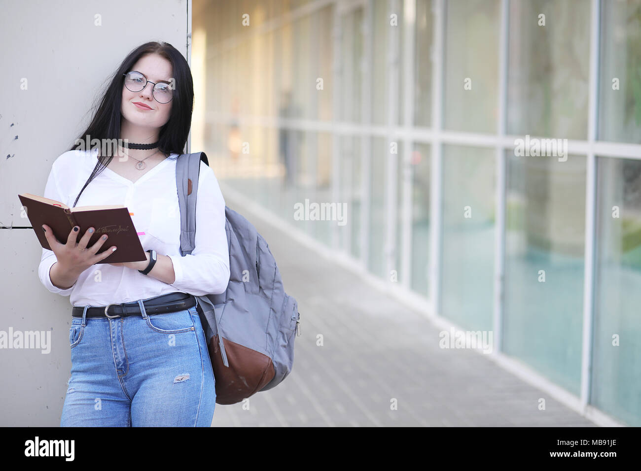 Girl student on the street with books Stock Photo - Alamy