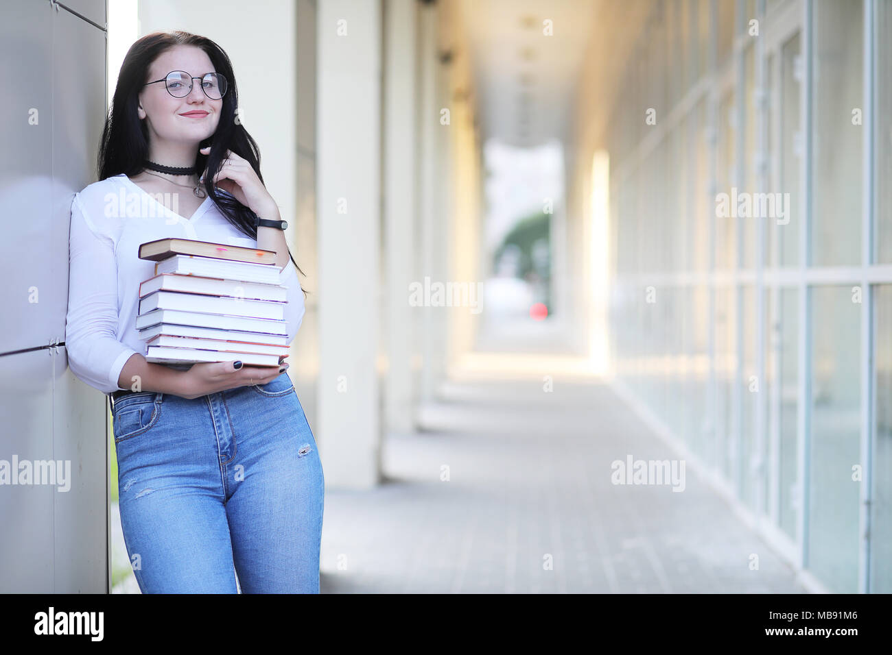 Girl student on the street with books Stock Photo - Alamy