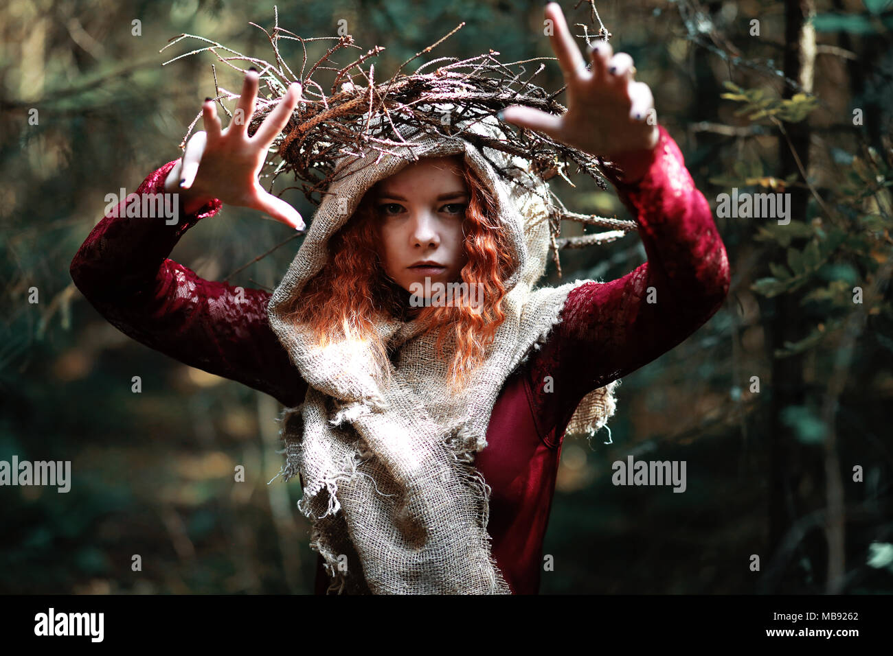 The red-haired witch holds a ritual with a crystal ball Stock Photo - Alamy