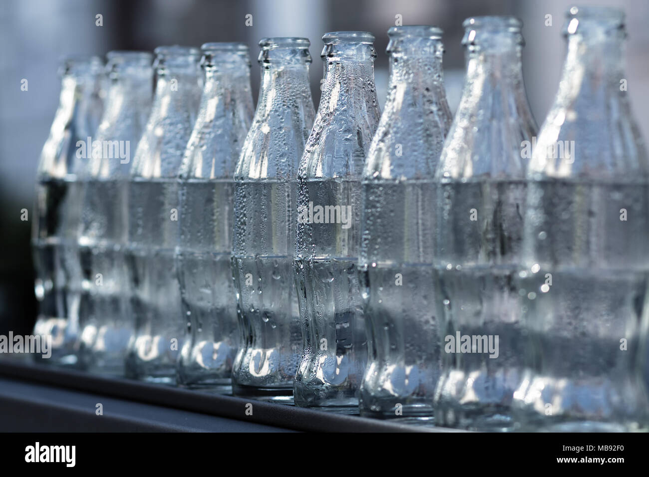 Raw of white, empty glass bottles, wet and washed Stock Photo - Alamy