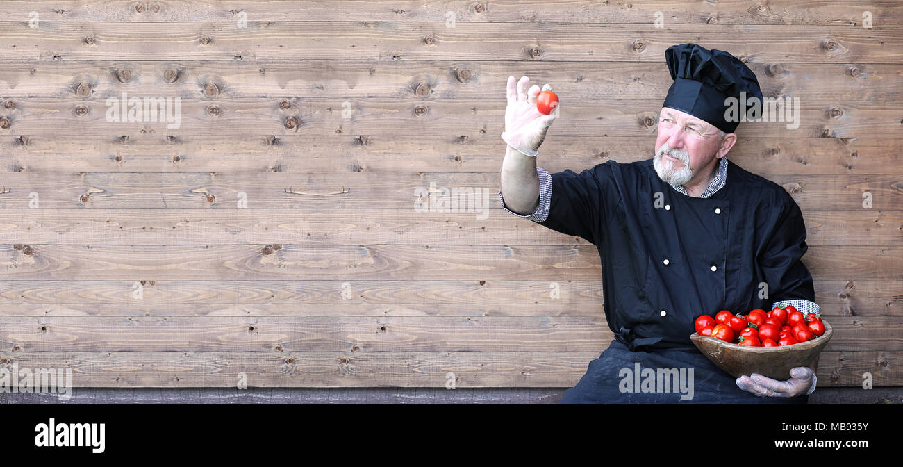 Chef old in uniform with vegetables Stock Photo - Alamy