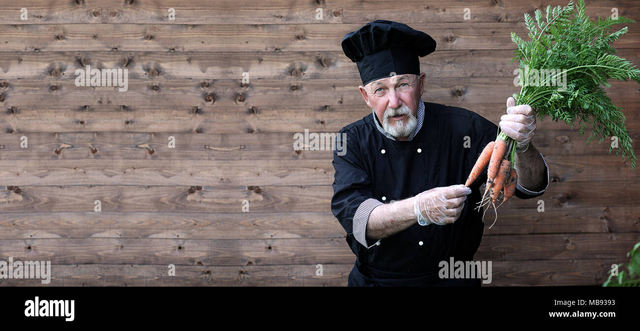 Chef old in uniform with vegetables Stock Photo - Alamy
