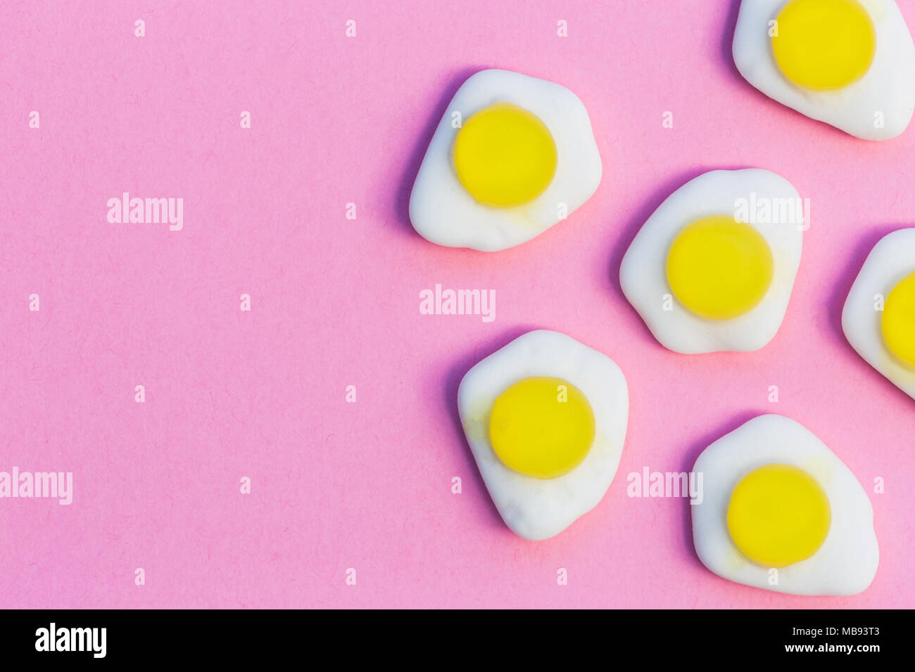 Fried eggs candy sweets on bright pink background with copy space Stock ...
