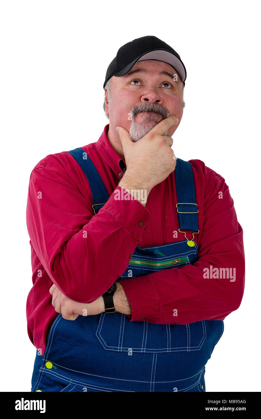 Confused slow-witted worker or farmer standing with his hand to his ...