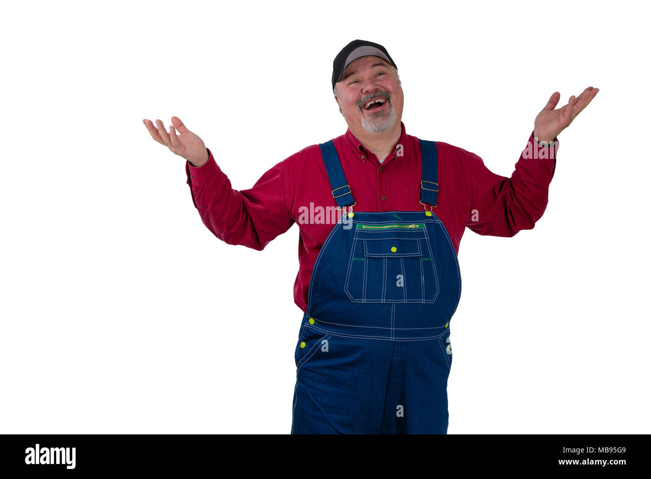 Laughing big-hearted magnanimous man in denim dungarees and cap ...