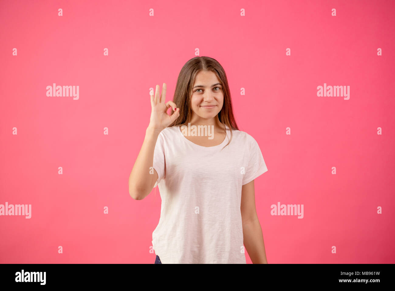 good-looking model with green eyes showing the gesture of agreement ...