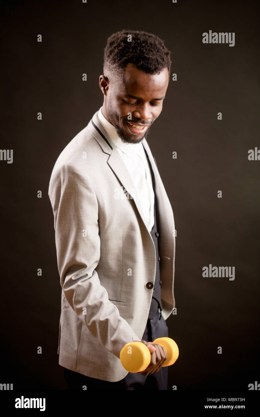 close up portrait of strong business man with white dumbbell isolated ...