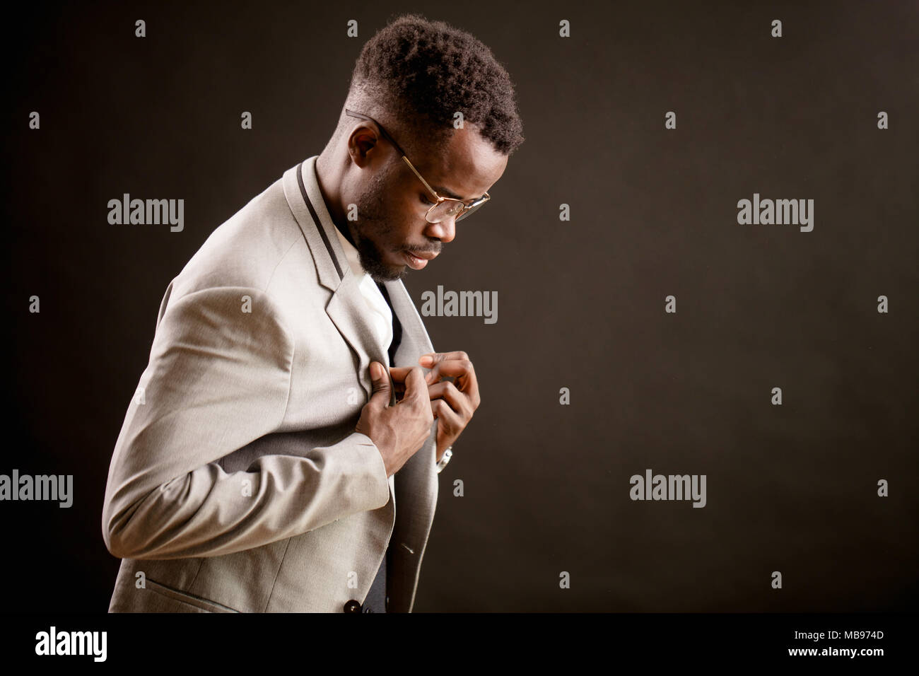 close up shot of African man who has lost his button of the suit Stock ...