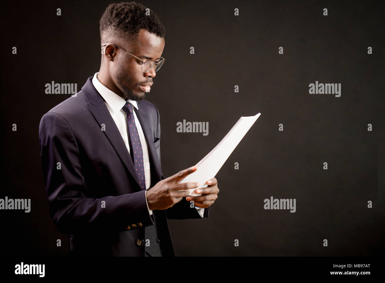 Successful worker reading papers in the office Stock Photo - Alamy