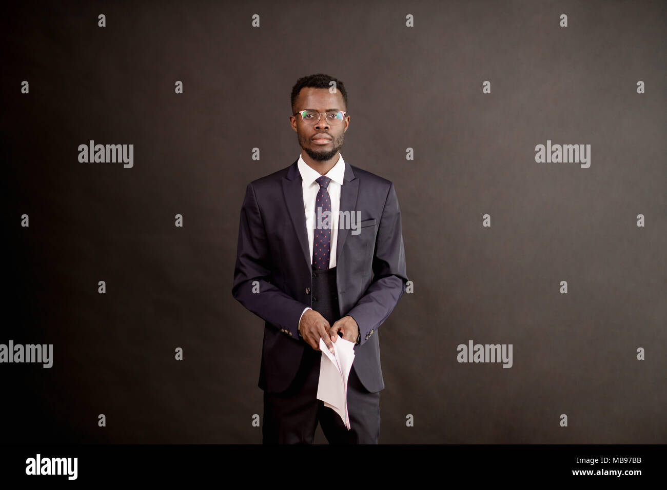 serious black guy with contract on his hands Stock Photo - Alamy