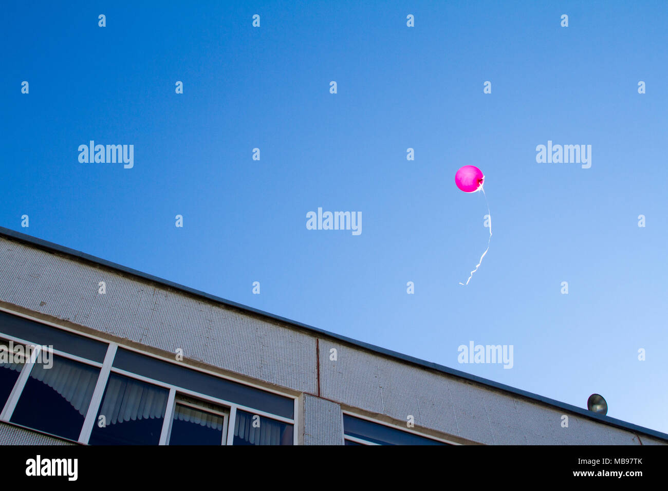 Colorful multicolored inflatable balls fly in air against background of ...