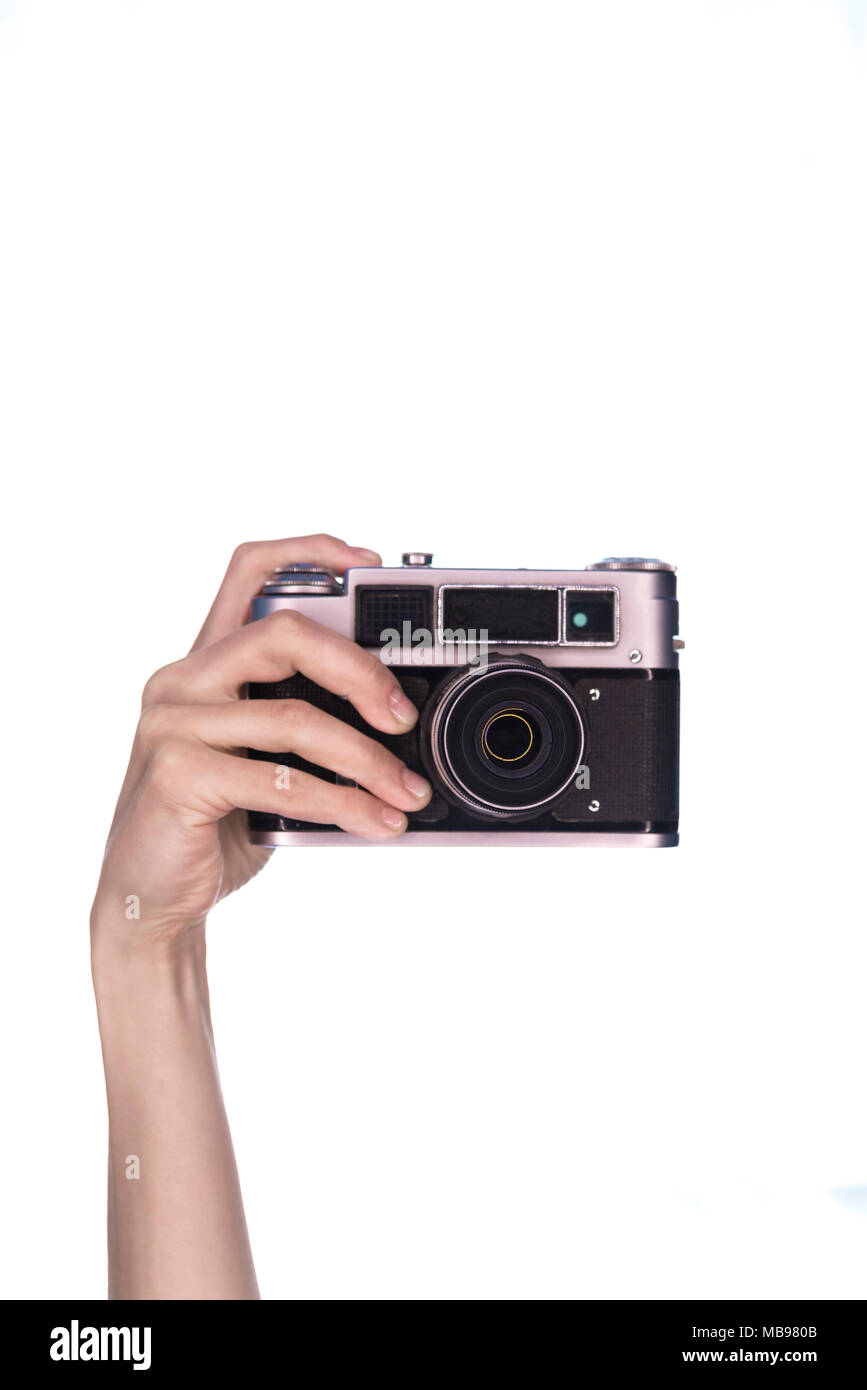 female hand holds an old camera on a white background Stock Photo - Alamy