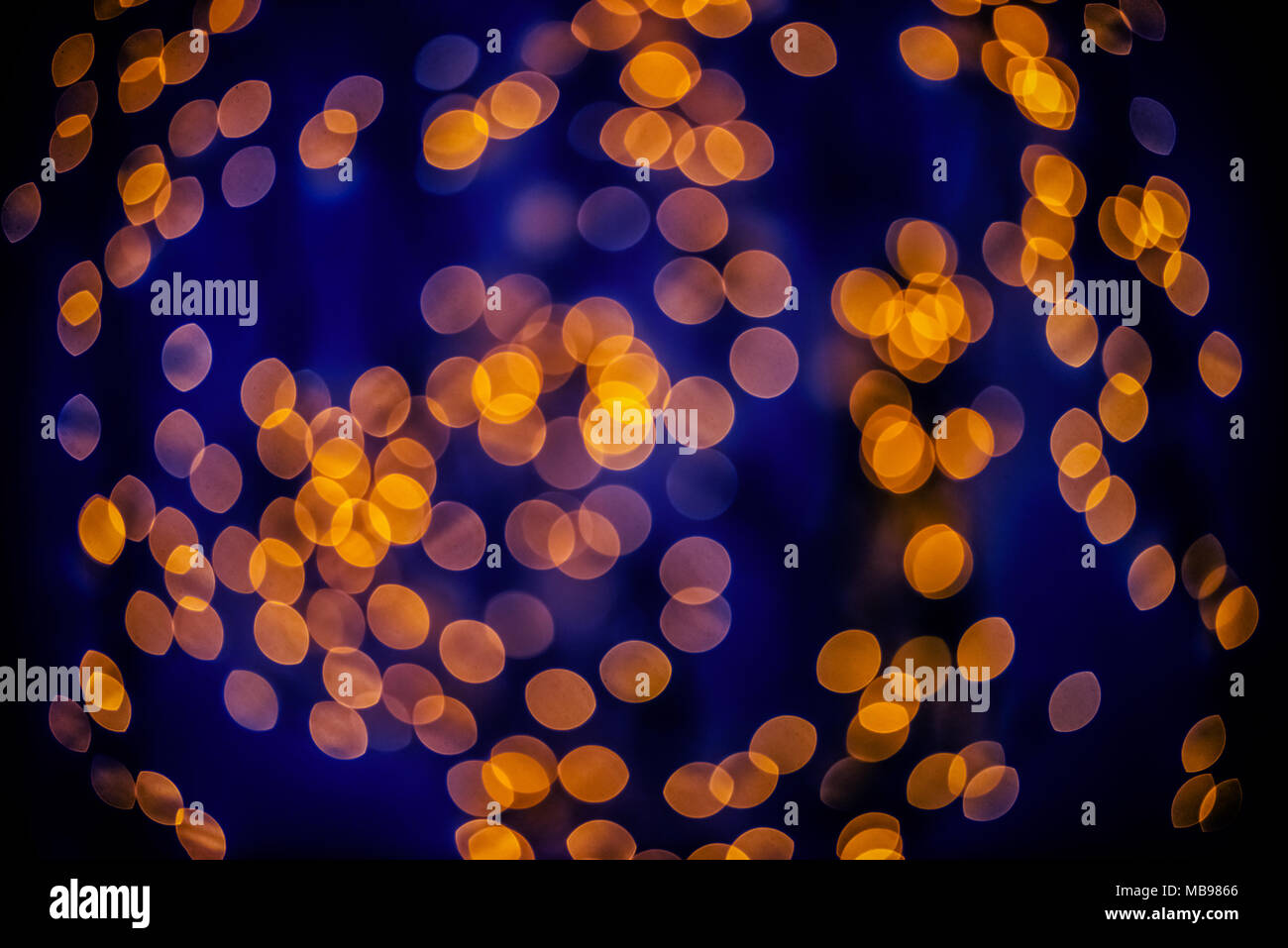 Bokeh background glowing oval shaped glow dark orange and dark blue ...