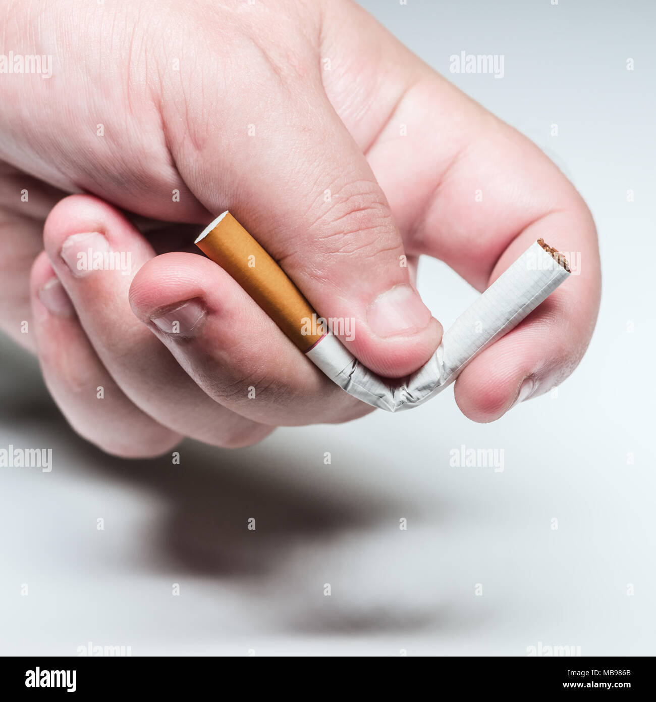 Quit smoking conceptual image male hand bending a cigarette Stock Photo ...