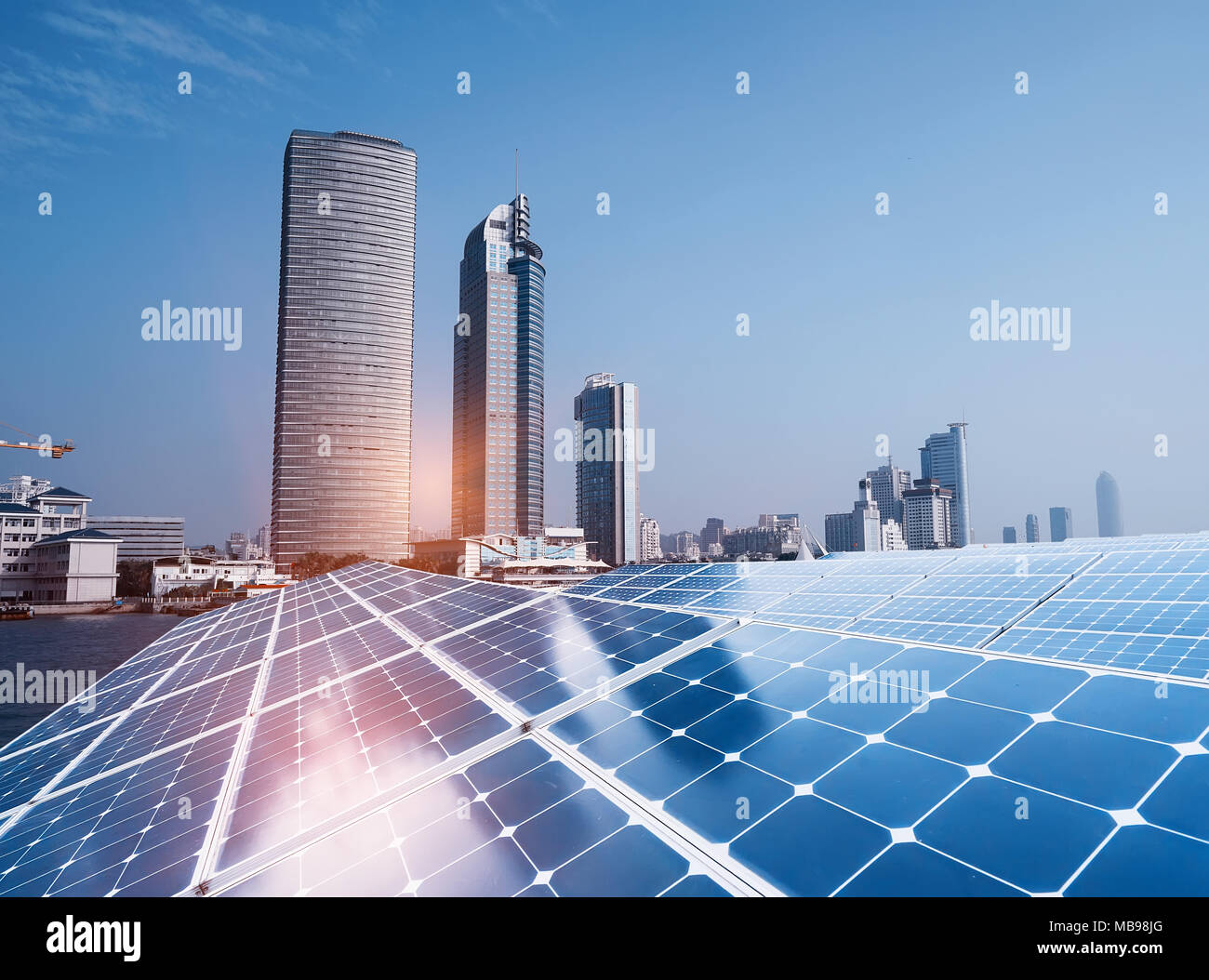 Ecological energy renewable solar panel plant with urban landscape ...