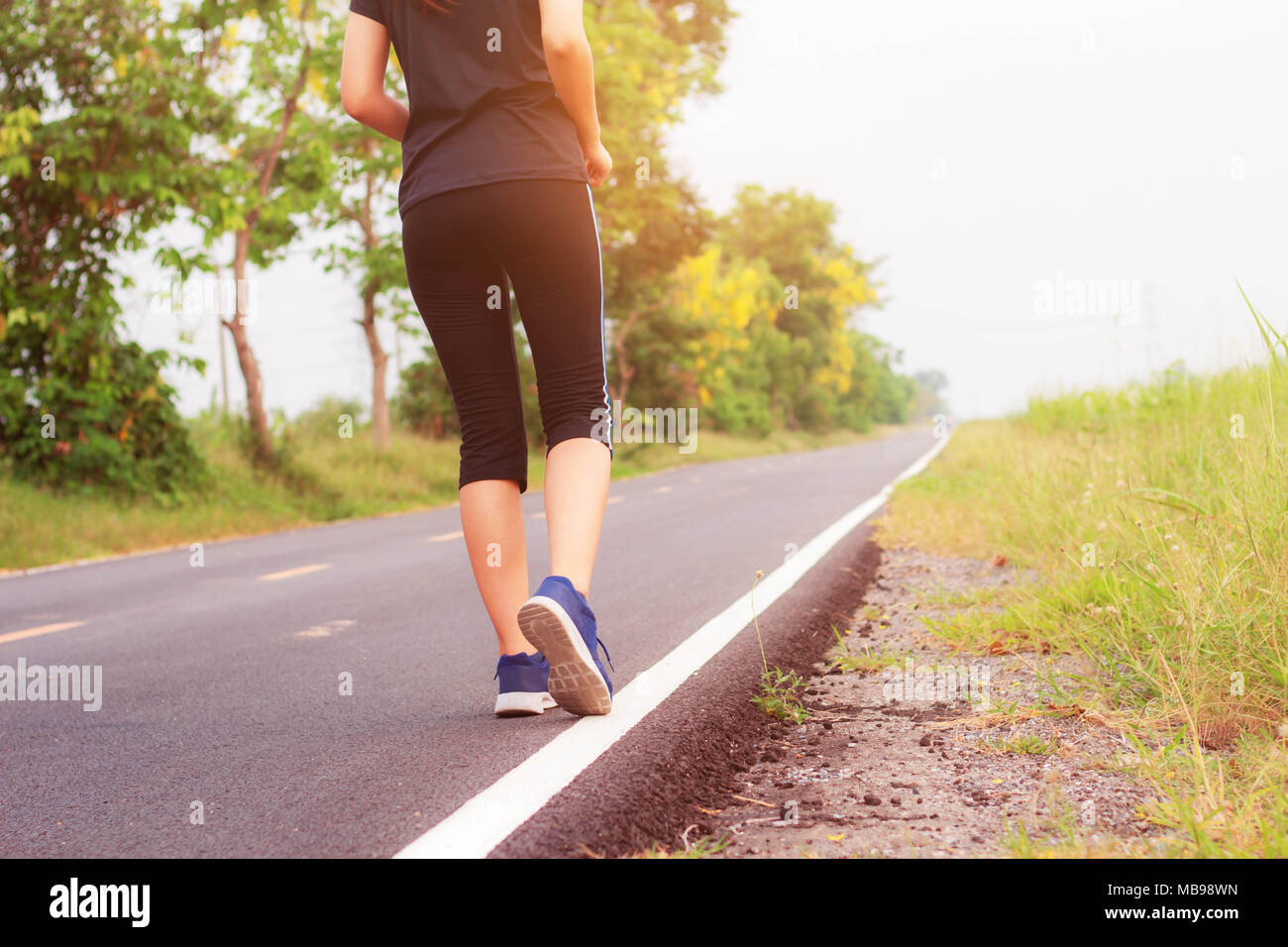 Girl is jogging on the street at sunlight Stock Photo - Alamy