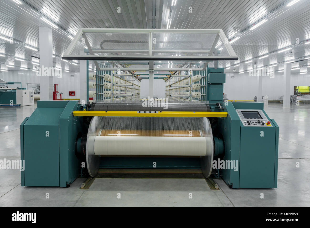 textile yarn on the wrapping machine is screwed on the big shaft ...