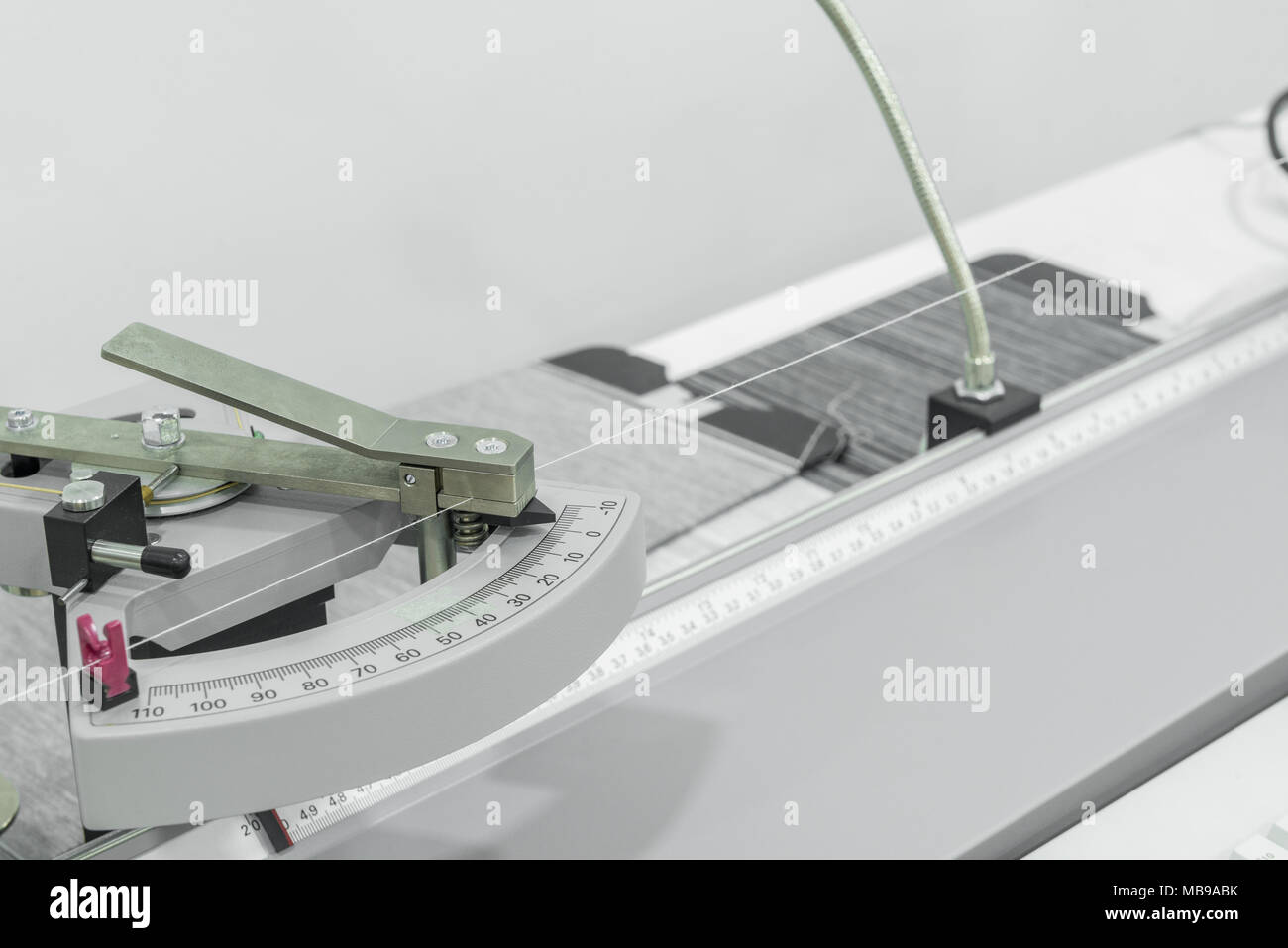 laboratory equipment measures the quality of cotton thread for strength ...