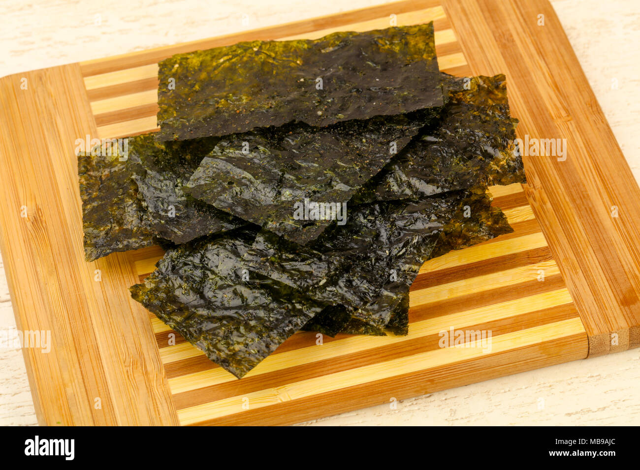 Crispy Nori sheets chips over wooden background Stock Photo - Alamy
