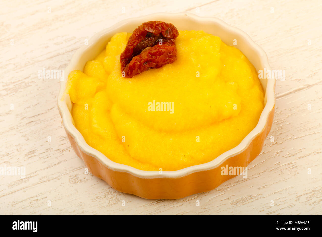 Polenta with dry tomato Stock Photo - Alamy