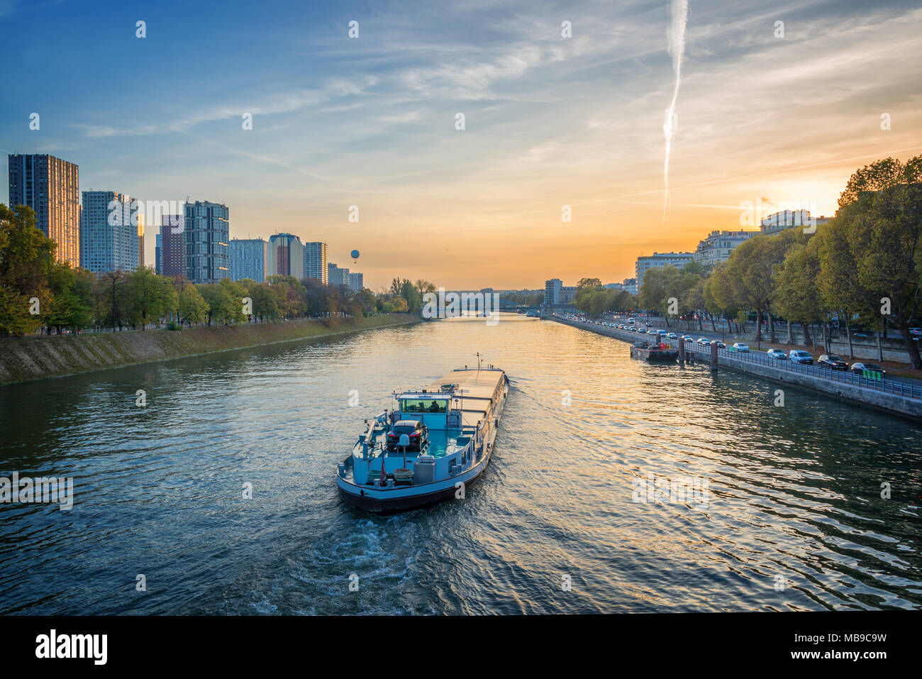 Barge on the river Seine at sunset, Paris France Stock Photo - Alamy