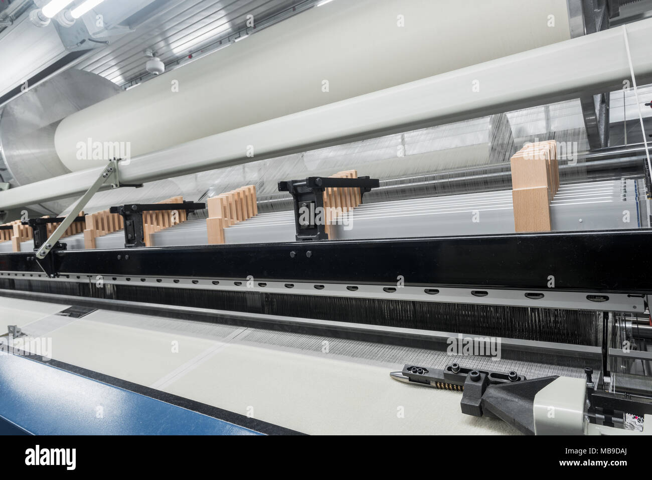 weaving loom at a textile factory, closeup. industrial fabric ...