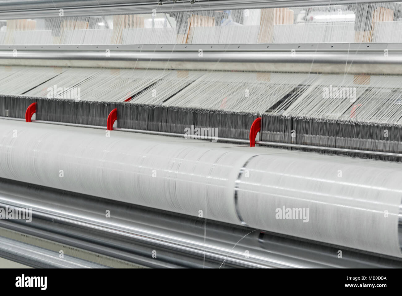 weaving loom at a textile factory, closeup. industrial fabric ...