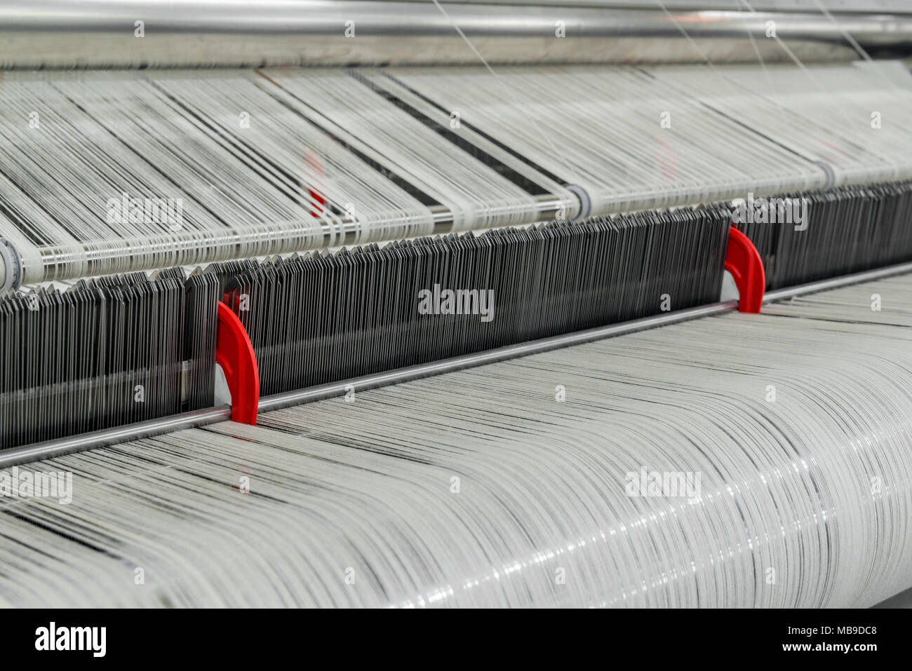 weaving loom at a textile factory, closeup. industrial fabric ...