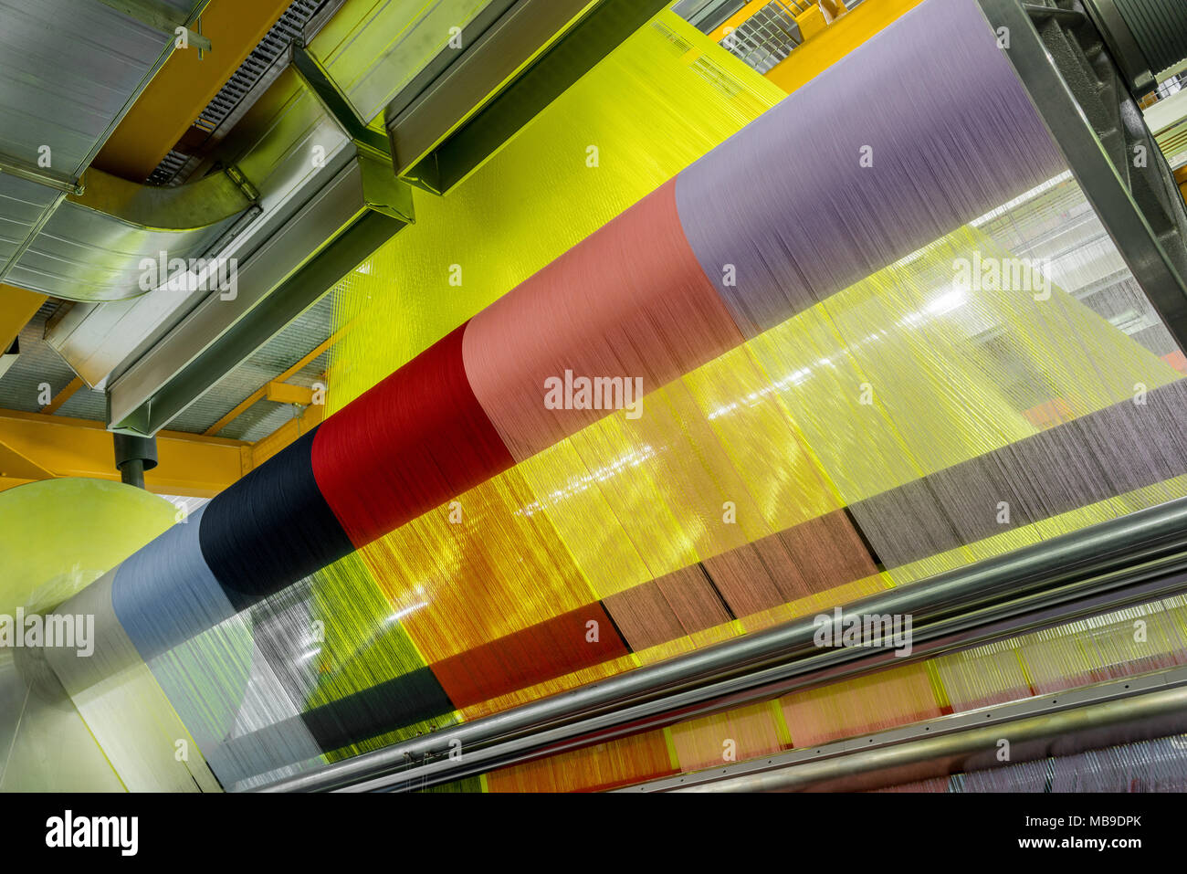 weaving loom at a textile factory, closeup. industrial fabric ...