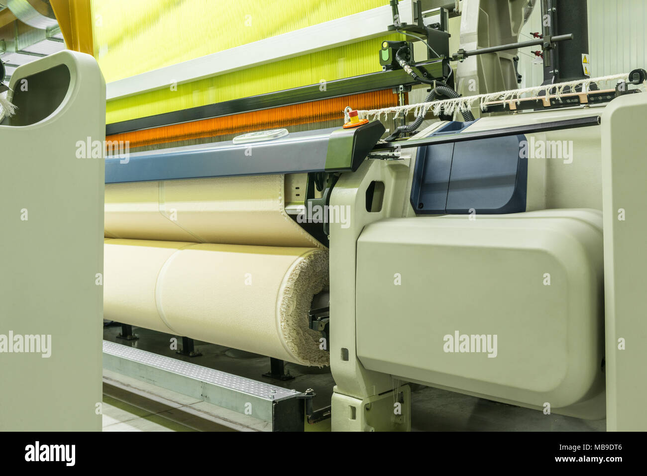 weaving loom at a textile factory, closeup. industrial fabric ...