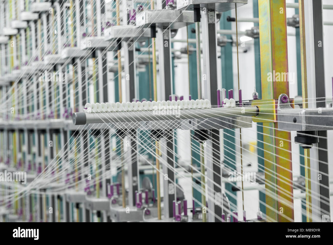 macro shot of a stretched thread. machinery and equipment in a textile ...