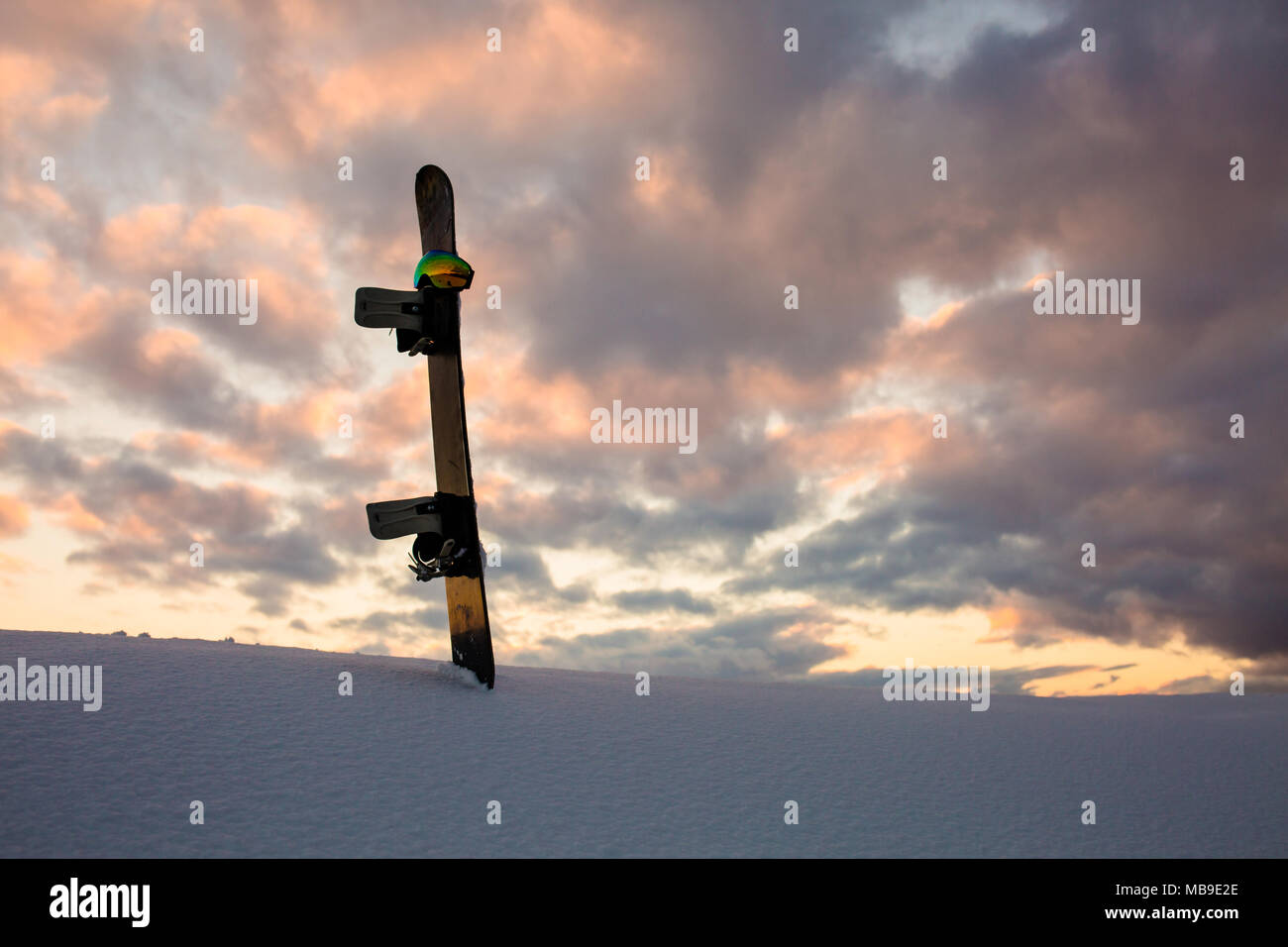 Snowboard on the slope at sunset and powder texture Stock Photo - Alamy