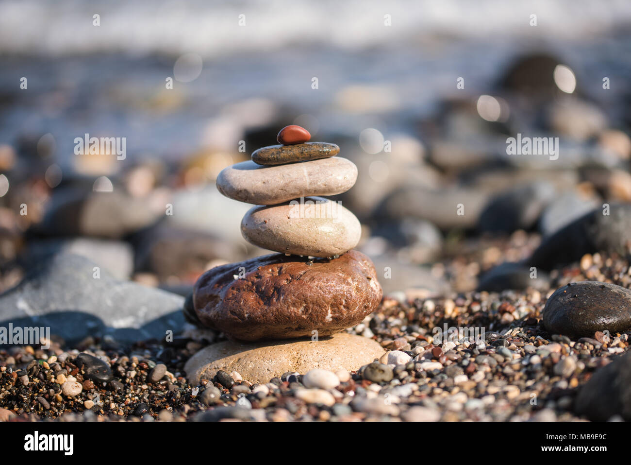 Stack of pebble stones on white background Stock Photo - Alamy