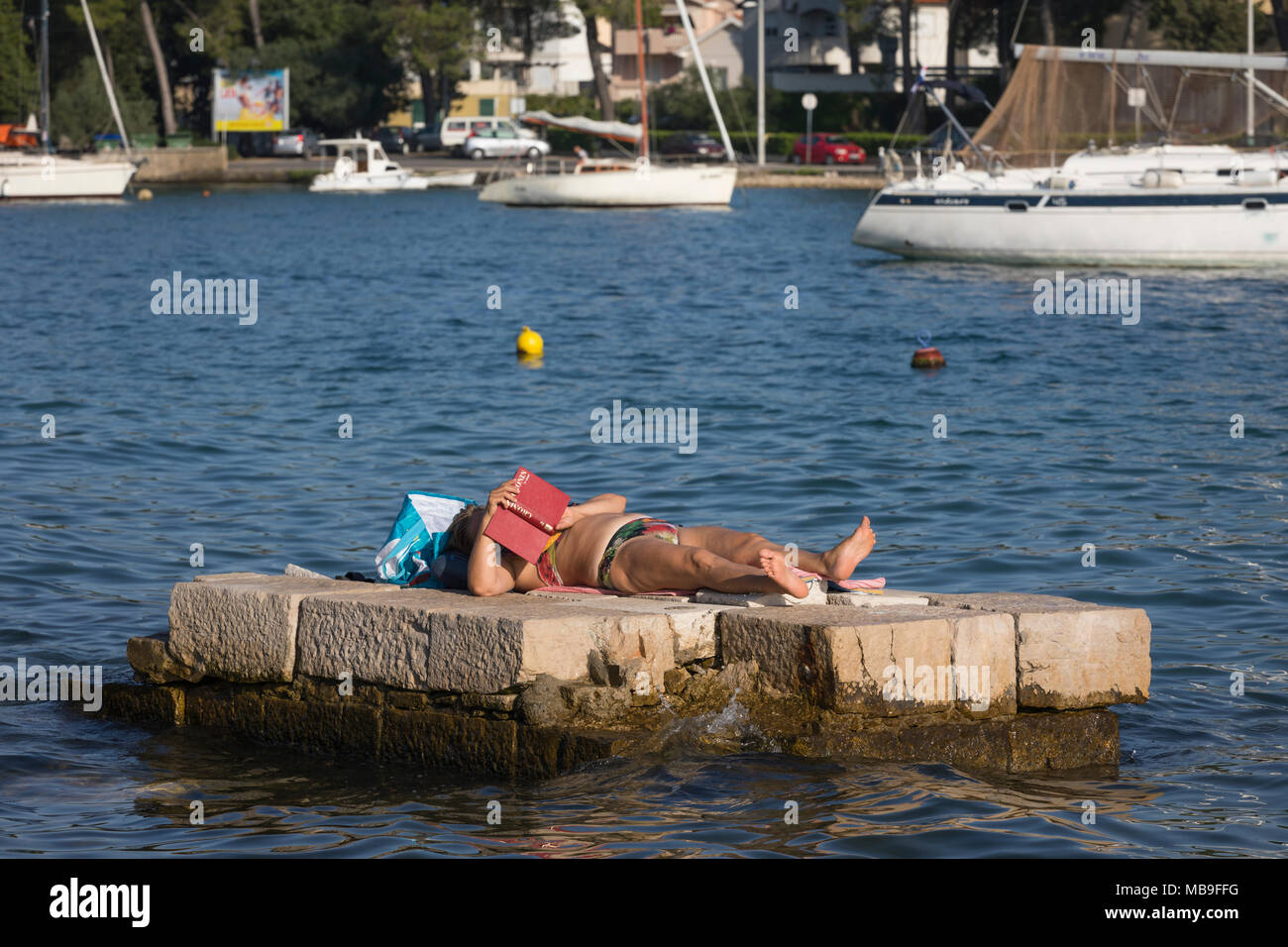 Middle aged woman sunbathing hi-res stock photography and images - Alamy